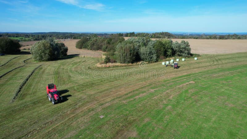 The Process of Harvesting Hay in Bales, Packing Hay Bales in Plastic ...