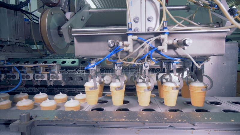 Ice Cream Production Process. Making Ice Cream in a Cup at the Factory ...
