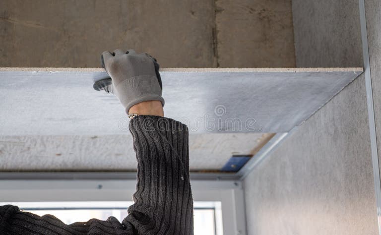 Process of Installing Drywall on Concrete Surfaces in Room with Hands ...