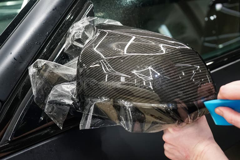 The Process of Installing PPF on the Side Mirror. Car Wrapping Close-up ...
