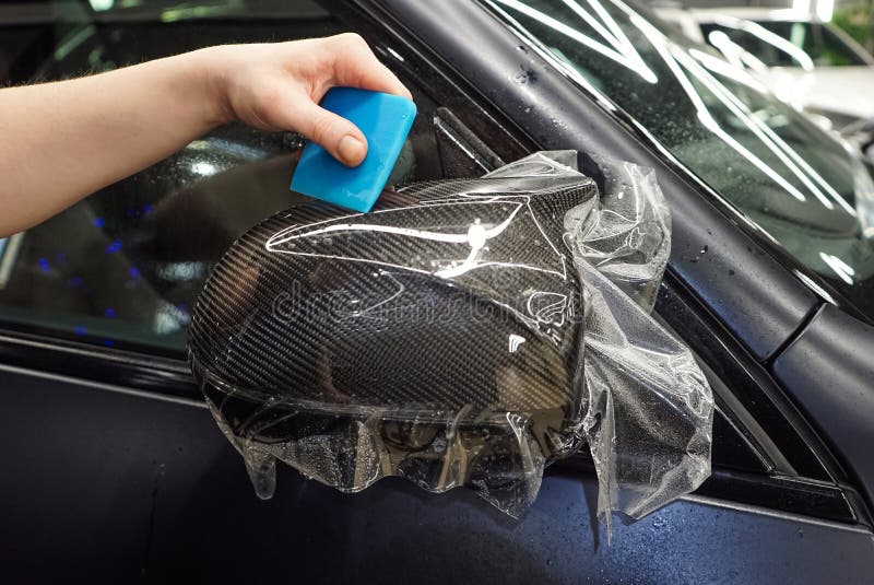 The Process of Installing PPF on the Side Mirror. Car Wrapping Close-up ...