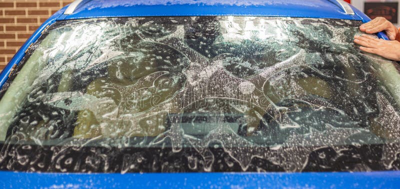 The Process of Installing the PPF on the Windshield of a Car. Stock ...
