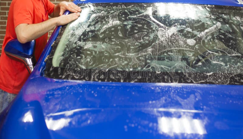 The Process of Installing the PPF on the Windshield of a Car. PPF is a ...