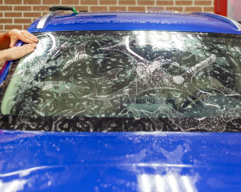 The Process of Installing the PPF on the Windshield of a Car. PPF is a ...