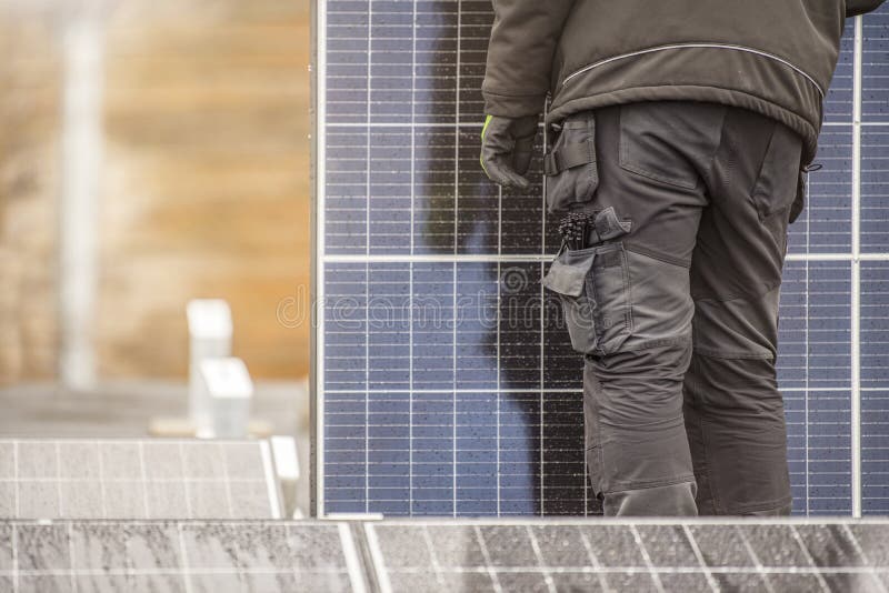 The Process of Installing Solar Panels. Solar Panel Installers Work on ...