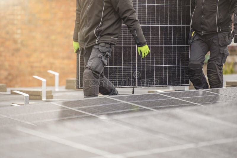 The Process of Installing Solar Panels. Solar Panel Installers Work on ...