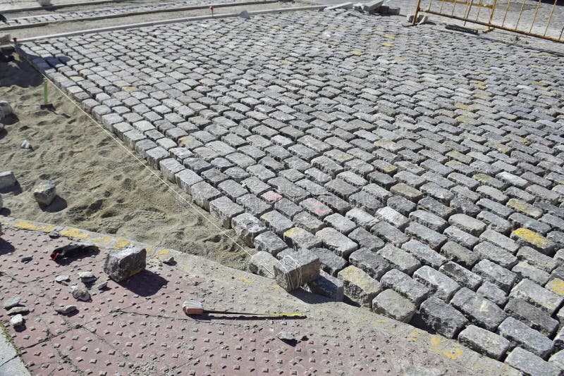 The Process of Laying Blocks on a Stone Pavement. Cadiz Stock Photo ...