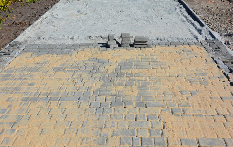The Process of Laying Cement Tiles To Create a Garden Path. after ...