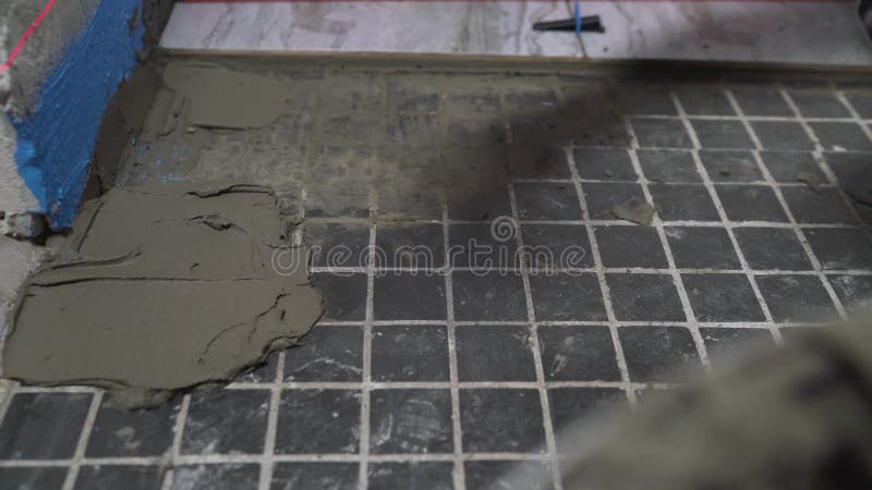 The Process of Laying Ceramic Floor Tiles. Spreading Wet Mortar before ...