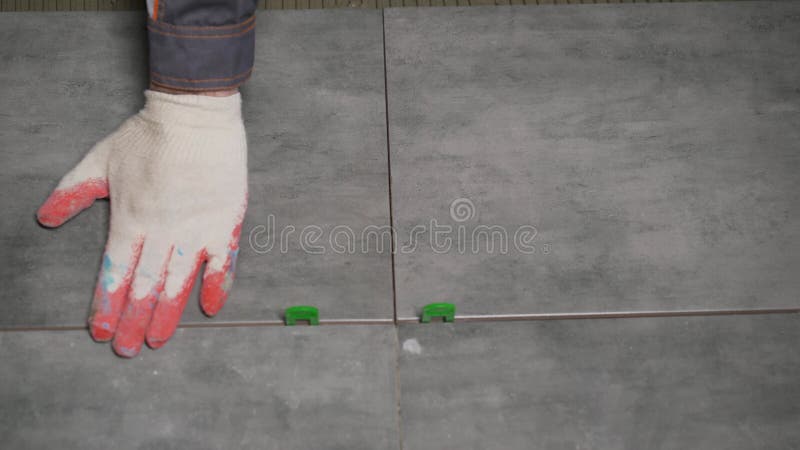 Laying of Ceramic Tiles at the Construction Site Stock Footage - Video of floor, worker: 262229820