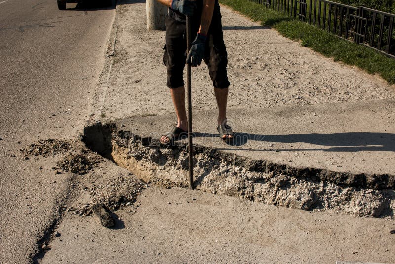 The Process of Laying the Sidewalk Curb. Workers Prepare a Trench for ...