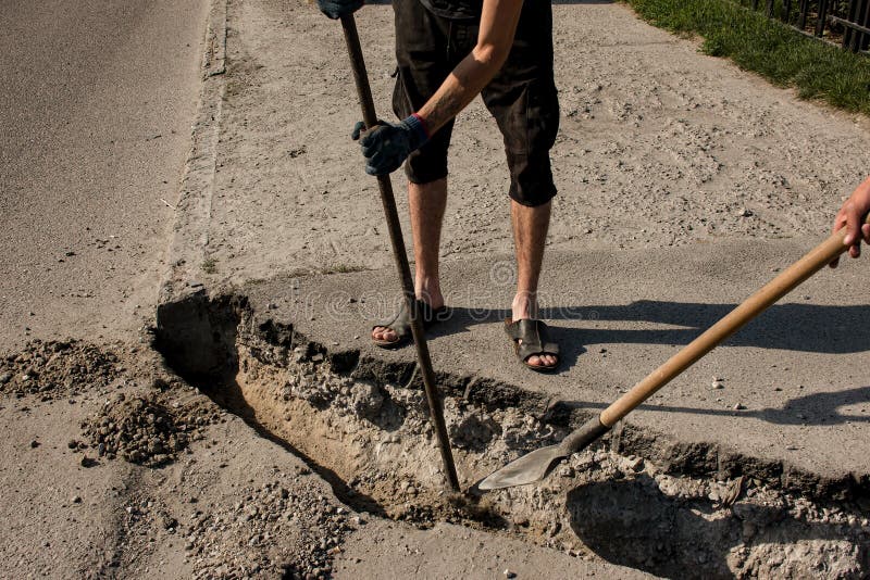 The Process of Laying the Sidewalk Curb. Workers Prepare a Trench for ...