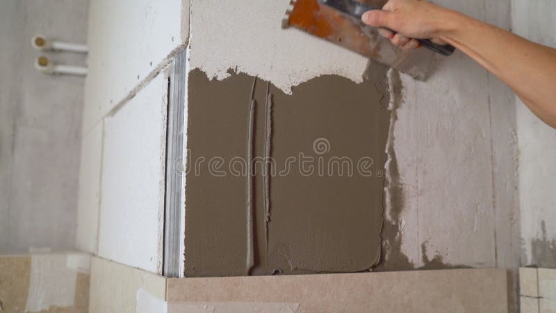 The Process of Laying Tiles. Applying Glue To the Wall Stock Photo ...