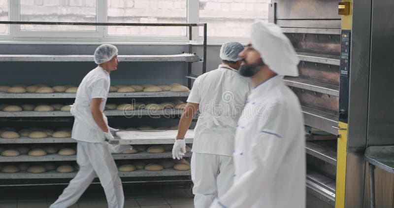 Process of Load the Raw Bread in the Oven Machine of Two Bakery Workers ...