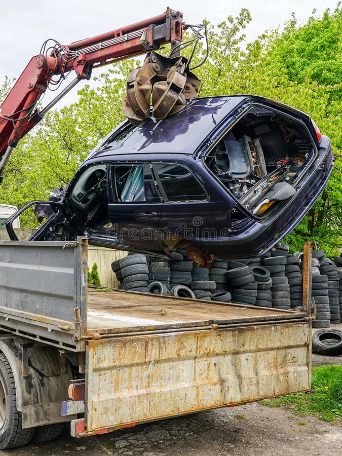 The Process of Loading an Abandoned Car Wreck Using a Hydraulic Loader ...