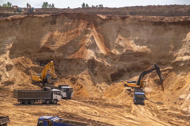 The Process of Loading Sand in a Sand Quarry. Trucks are Waiting for ...