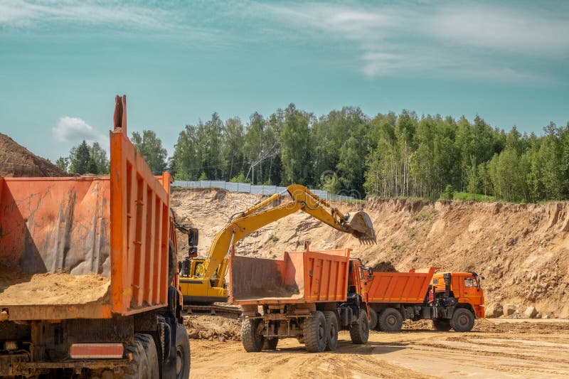 The Process of Loading Sand in a Sand Quarry. Trucks are Waiting for ...