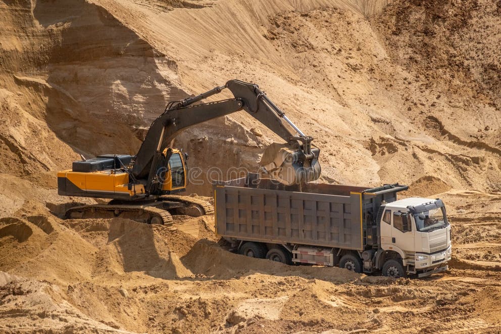 The Process of Loading Sand in a Sand Quarry. Trucks are Waiting for ...