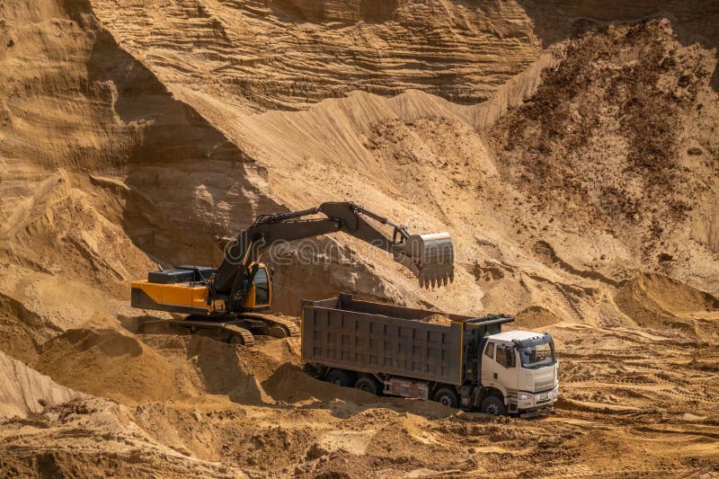 The Process of Loading Sand in a Sand Quarry. Trucks are Waiting for ...