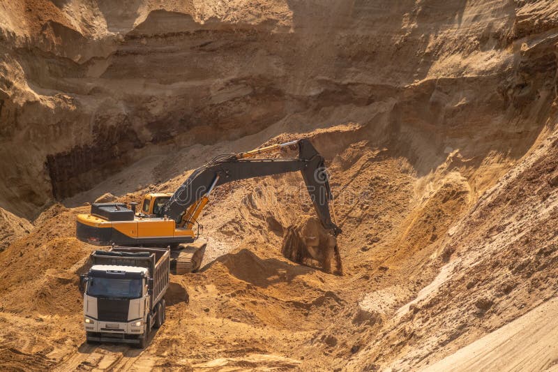 The Process of Loading Sand in a Sand Quarry. Trucks are Waiting for ...