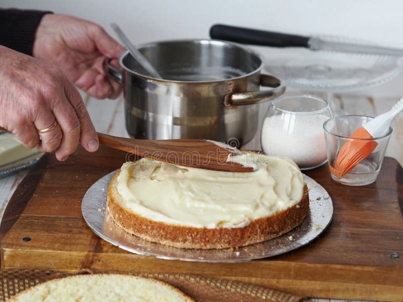 The Process of Making a Cake. Women is Hands Grease the Cake Layers ...