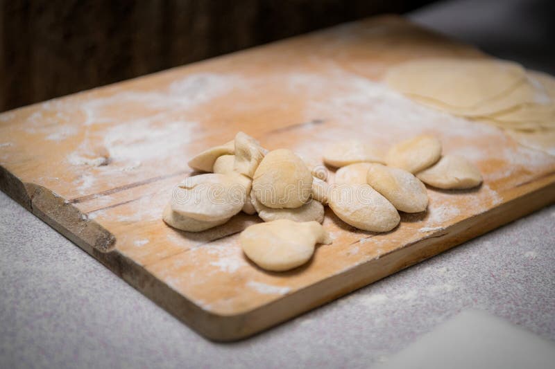 Process of Making Chinese Dumplings. Raw Dough on Wooden Chopping Board ...