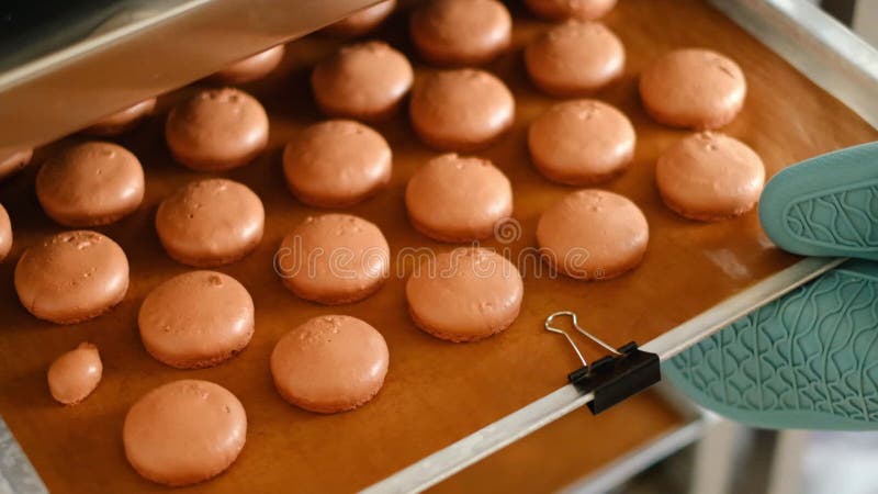 The Process of Making Confectionery. Baking Macarons in the Oven Stock ...