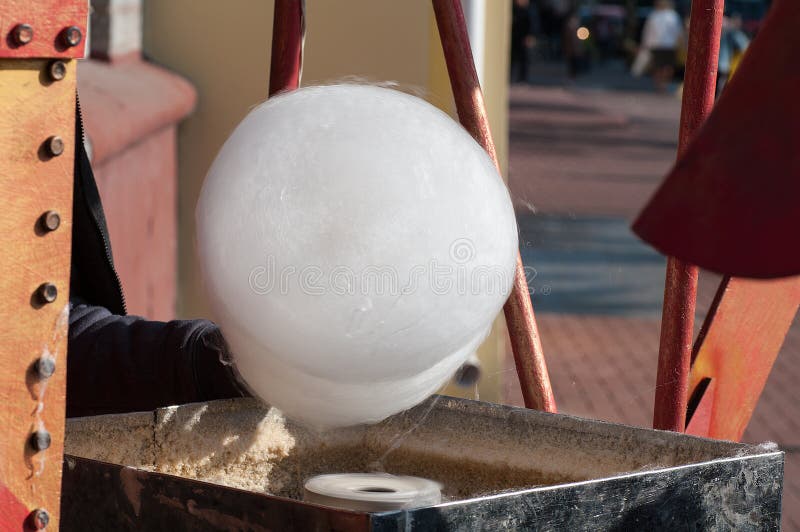 The Process of Making Cotton Candy, the Seller Winds a Stick of Cotton ...