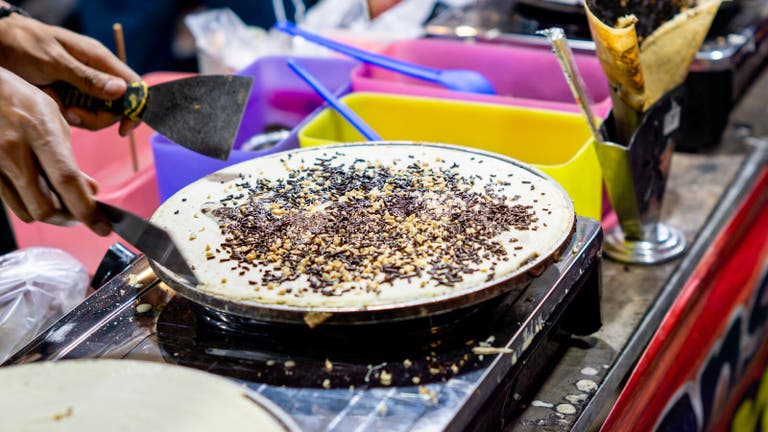 The Process of Making Crispy Crepes Filled with Various Different ...