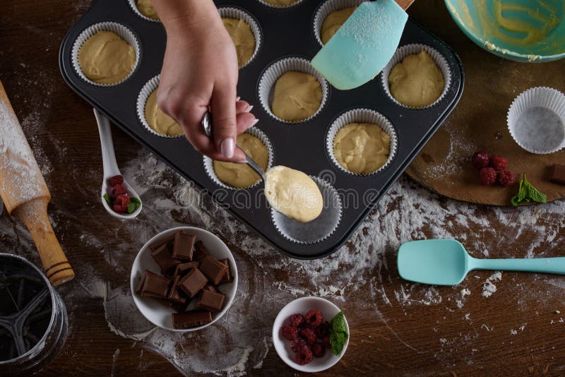 The Process of Making Cupcakes, Coating a Cream from a Pastry Bag in ...