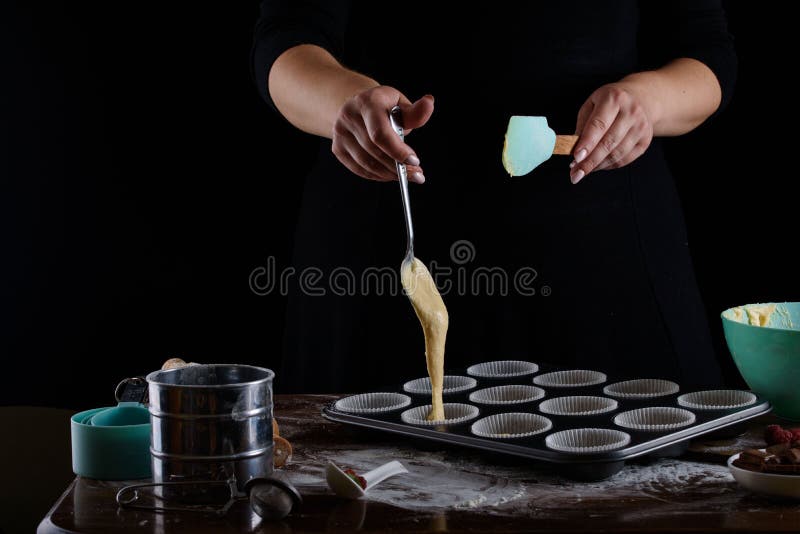 The Process of Making Cupcakes, Coating a Cream from a Pastry Bag in ...