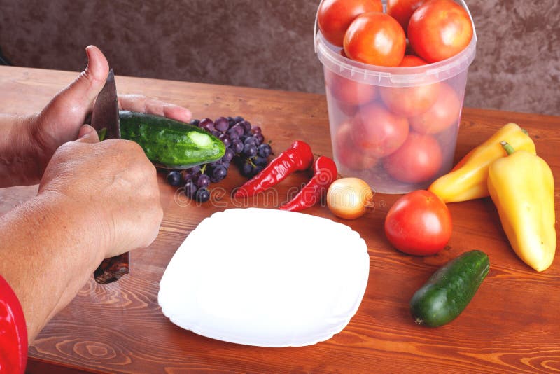 The Process of Making Fresh Vegetable Salad on a Wooden Table Stock ...
