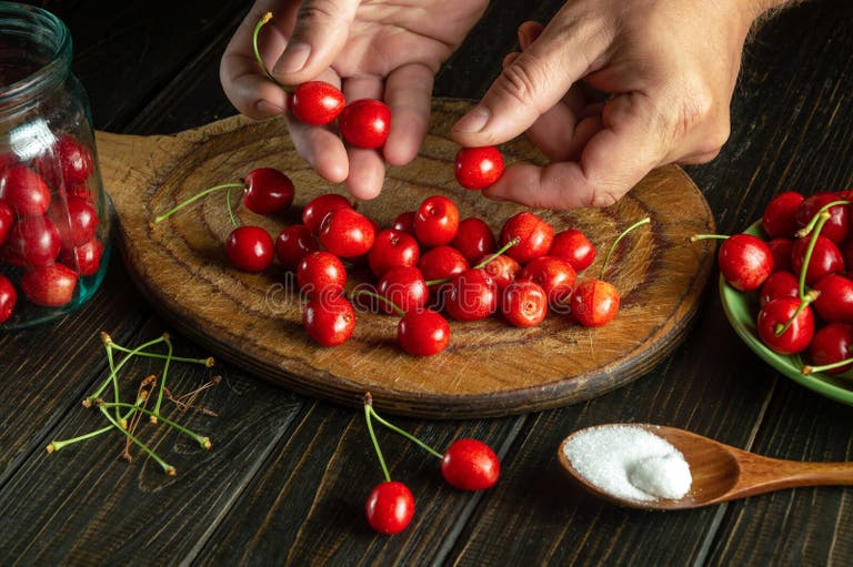 The Process of Making Fruit Drink from Fresh Cherries on the Kitchen ...