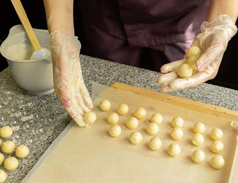 The Process of Making Handmade Chocolates. Round Chocolate Candies in ...