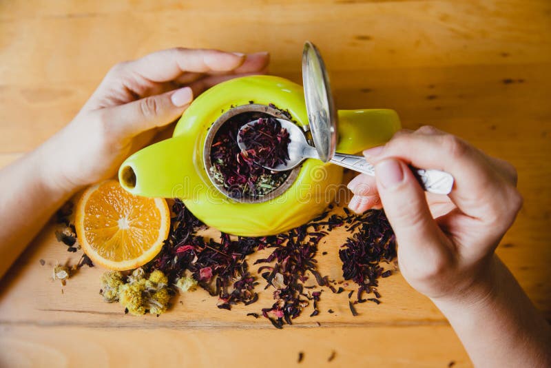 The Process of Making Herbal Tea in a Green Teapot on a Wooden Table ...