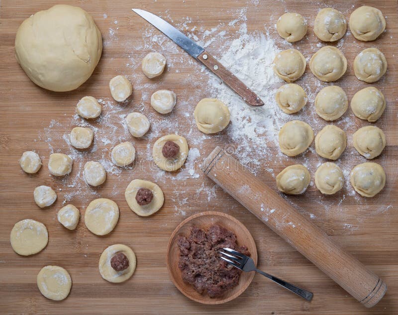 The Process of Making Home-made Dumplings. Raw Homemade Dumplings on a ...