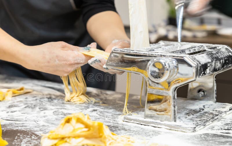 The Process of Making Homemade Pasta Using a Pasta Machine. the Image ...