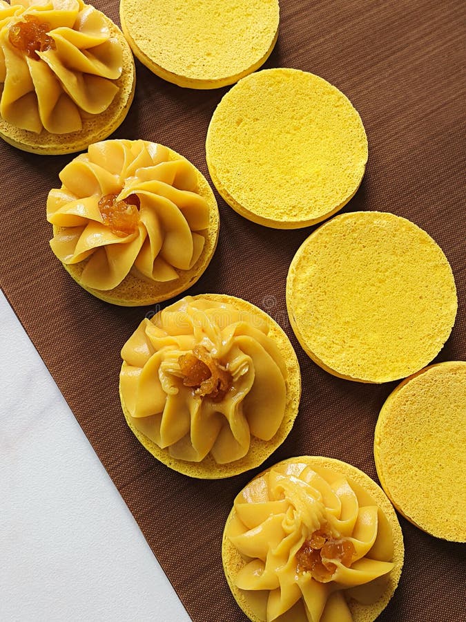 Process of Making Macarons. Filling with Mango and Passion Fruit on ...