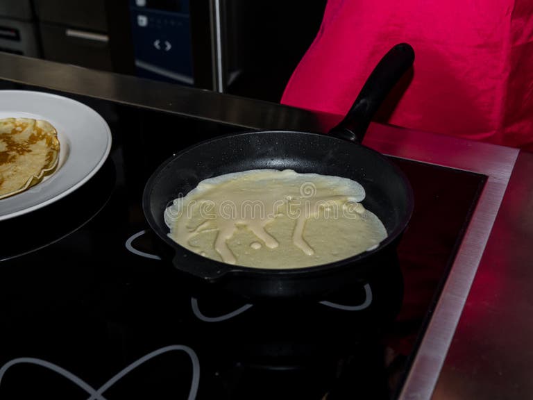 The Process of Making Pancakes. Cook in the Kitchen Makes the Dough ...