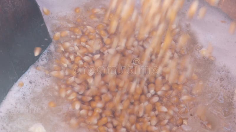 The Process of Making Popcorn by Pouring Corn Kernels into Hot Popcorn ...