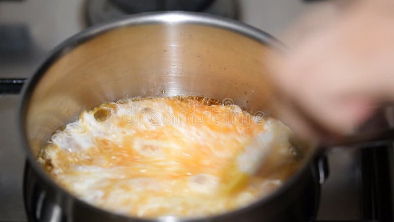 The Process of Making of the Soft Caramel at Home. Adding Cream. Stock ...