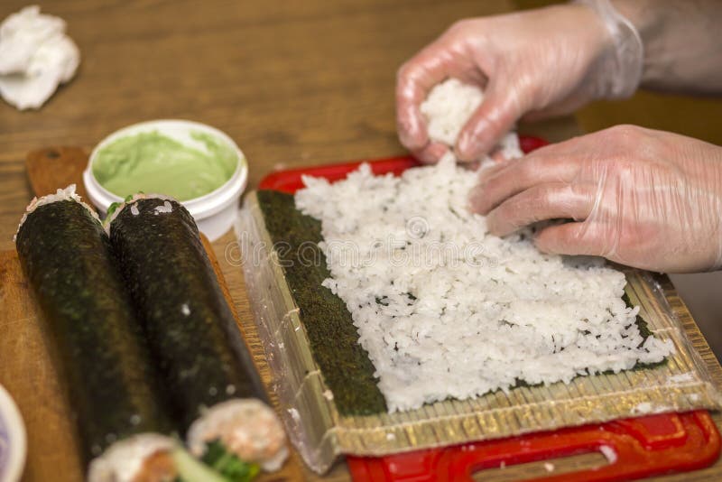 Process Of Making Sushi And Rolls Close Up Of Man Chef Hands Preparing Traditional Japanese