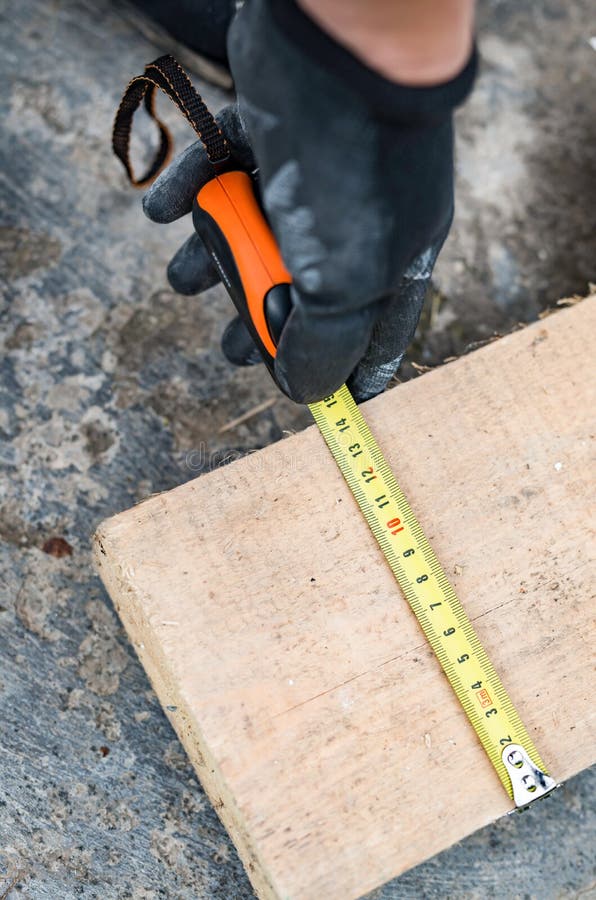 The Process of Measuring the Length of a Wooden Beam Stock Image ...
