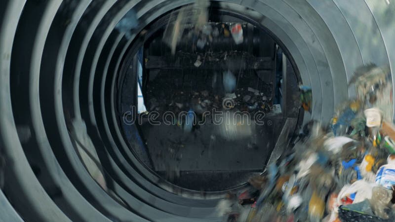 Process of Mechanical Garbage Sorting. Trash Falls from a Conveyor into ...