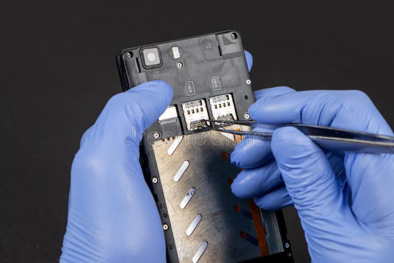 Process of Mobile Phone Repair. Hands of a Service Worker Repairing ...