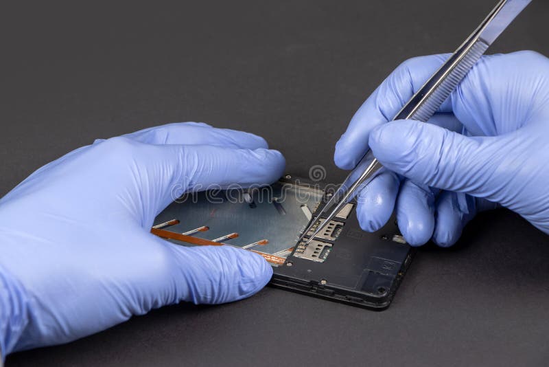 Process of Mobile Phone Repair. Hands of a Service Worker Repairing ...