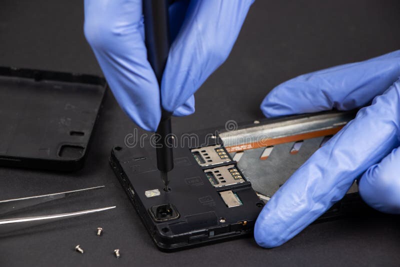 Process of Mobile Phone Repair. Hands of a Service Worker Repairing ...