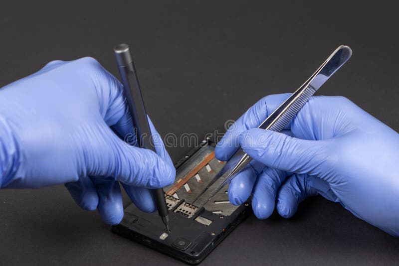 Process of Mobile Phone Repair. Hands of a Service Worker Repairing ...