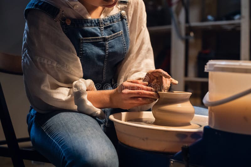 The Process of Modeling a Clay Vase Shows a Young Potter in His Studio ...