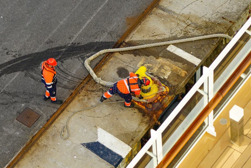 The Process of Mooring a Large Ship at the Harbor Pier, Pulling the ...